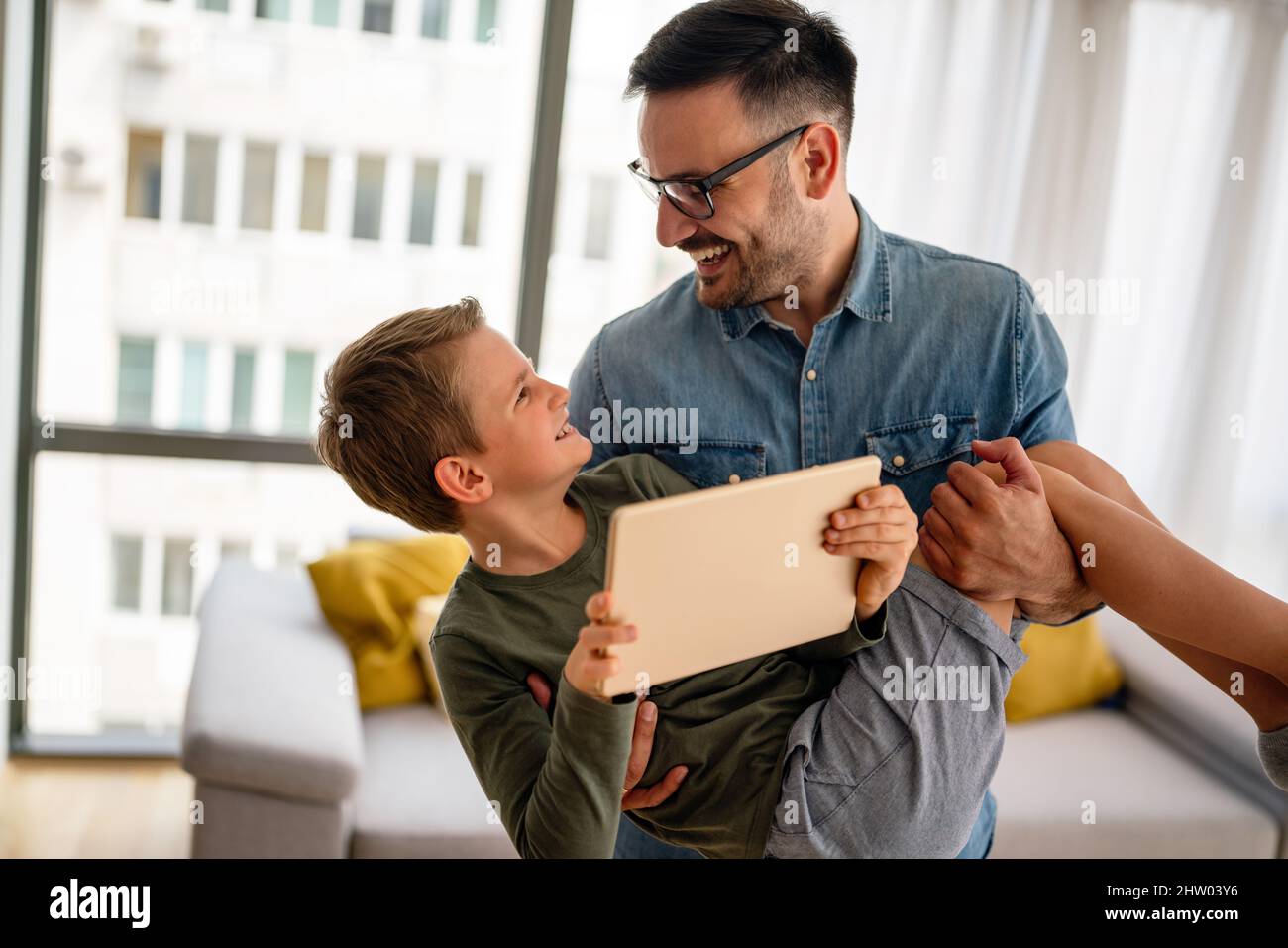 Father and child using digital tablet for e-learning. Education home digital device kid concept ...
