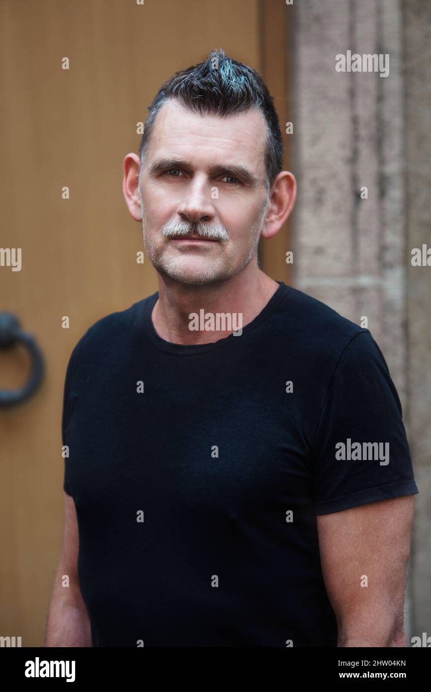 portrait a of handsome man in his 50s wearing a black t-shirt Stock ...