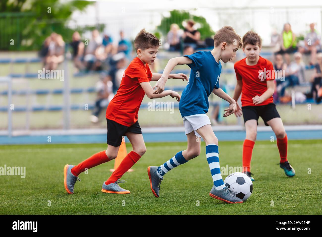 Young boys playing a football game. Training and soccer match between ...