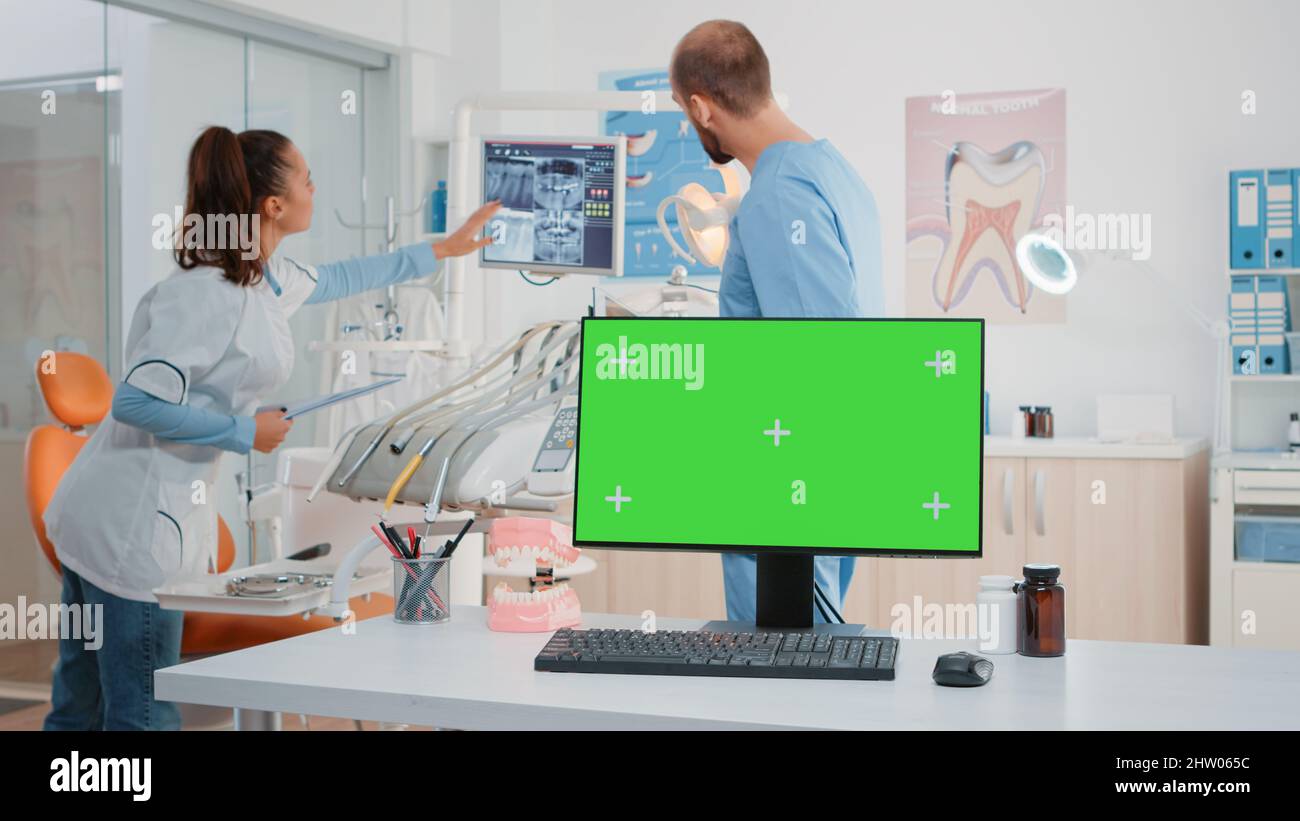 Dental cabinet with horizontal green screen on monitor. Modern dentist ...