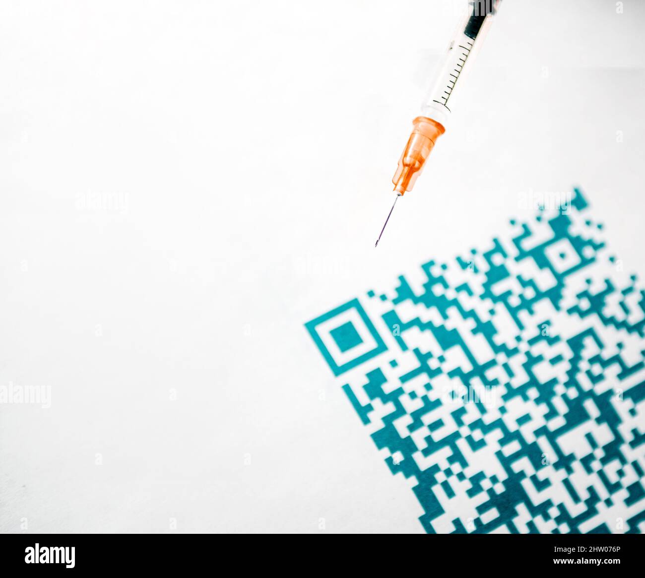 A QR code close up and medical syringe colored Stock Photo - Alamy