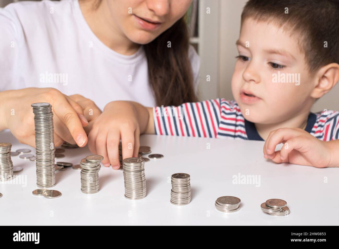 The parent teaches the child how to handle money. Financial literacy ...