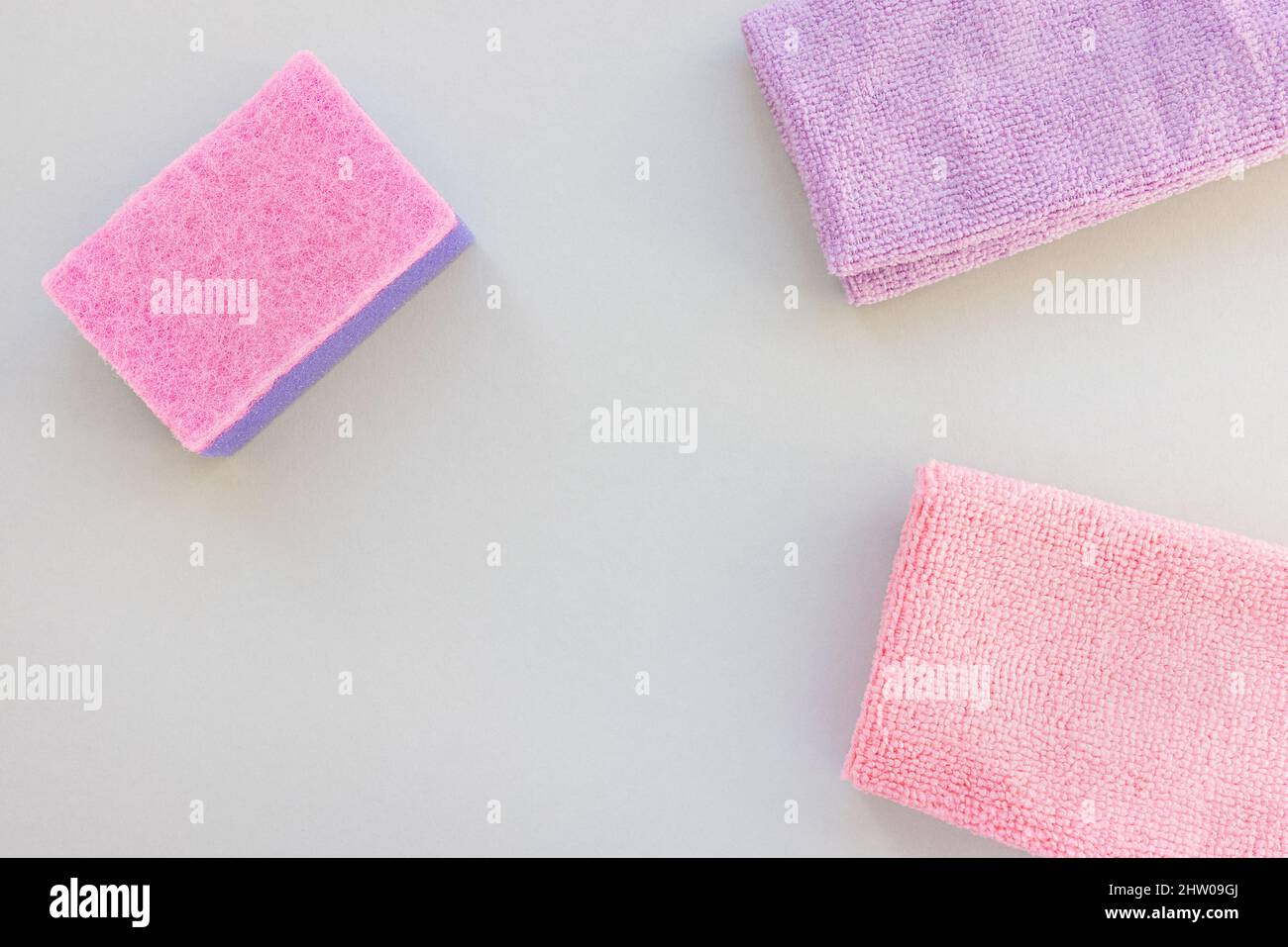 Pink and purple sponge and microfiber cloth for cleaning and dusting on ...