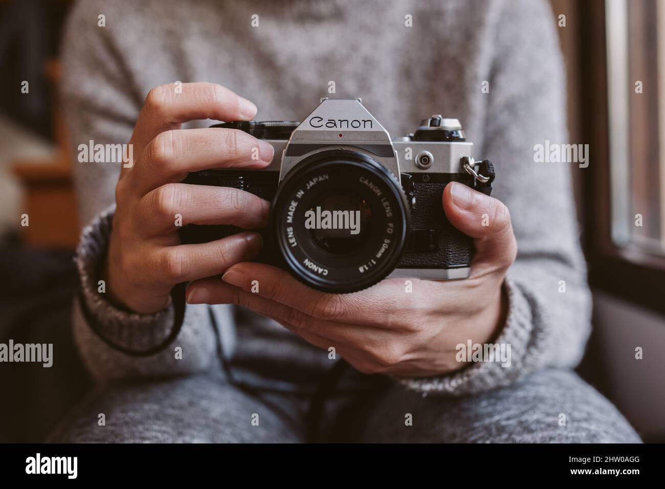 Canon AE 1 vintage film camera 35 mm in hand Stock Photo - Alamy