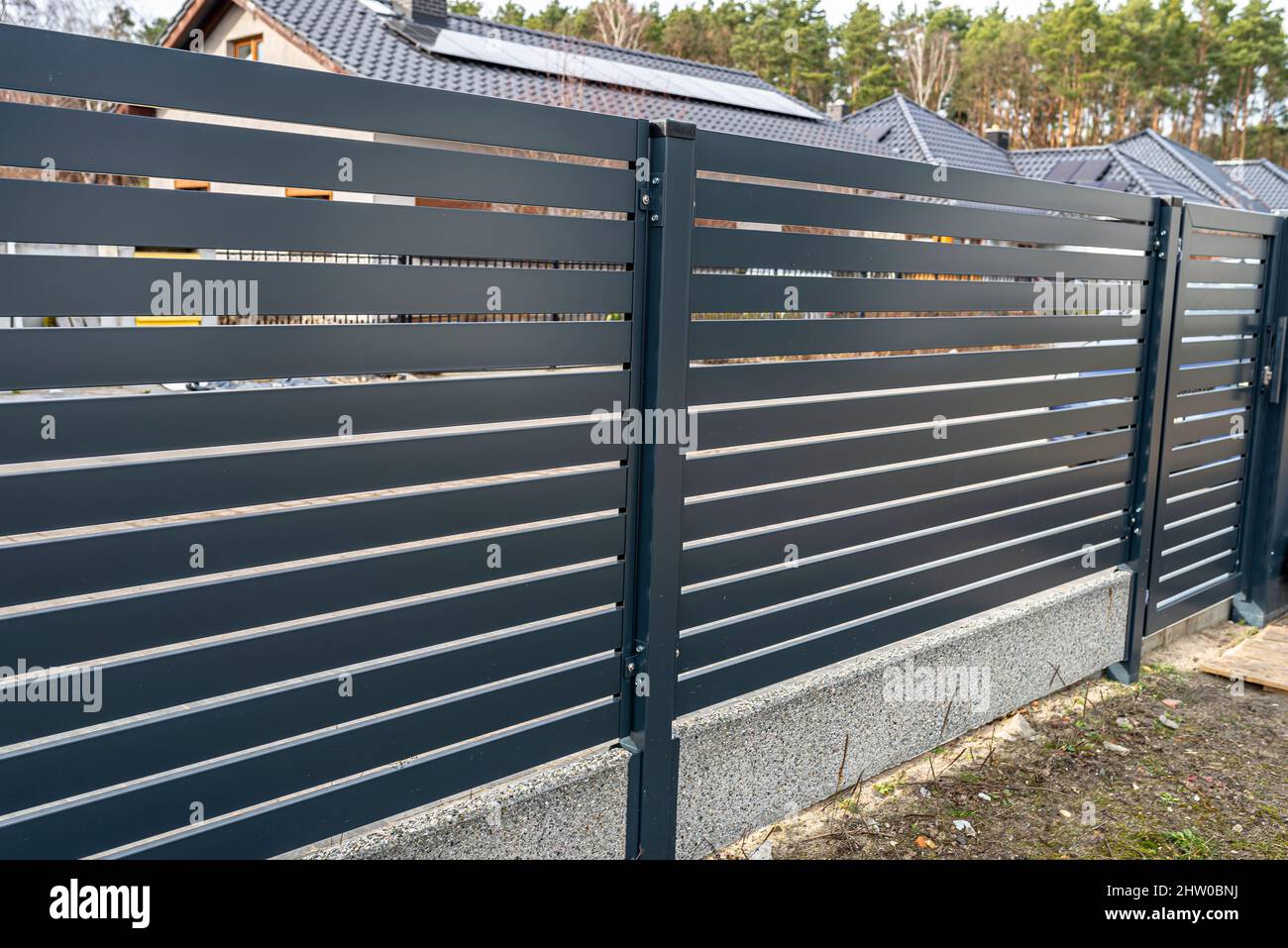 Modern anthracite panel fencing, visible spans and a fence foundation ...