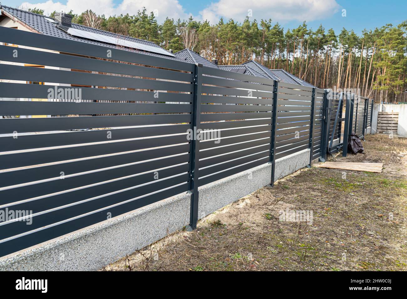 Modern anthracite panel fencing, visible spans and a fence foundation ...