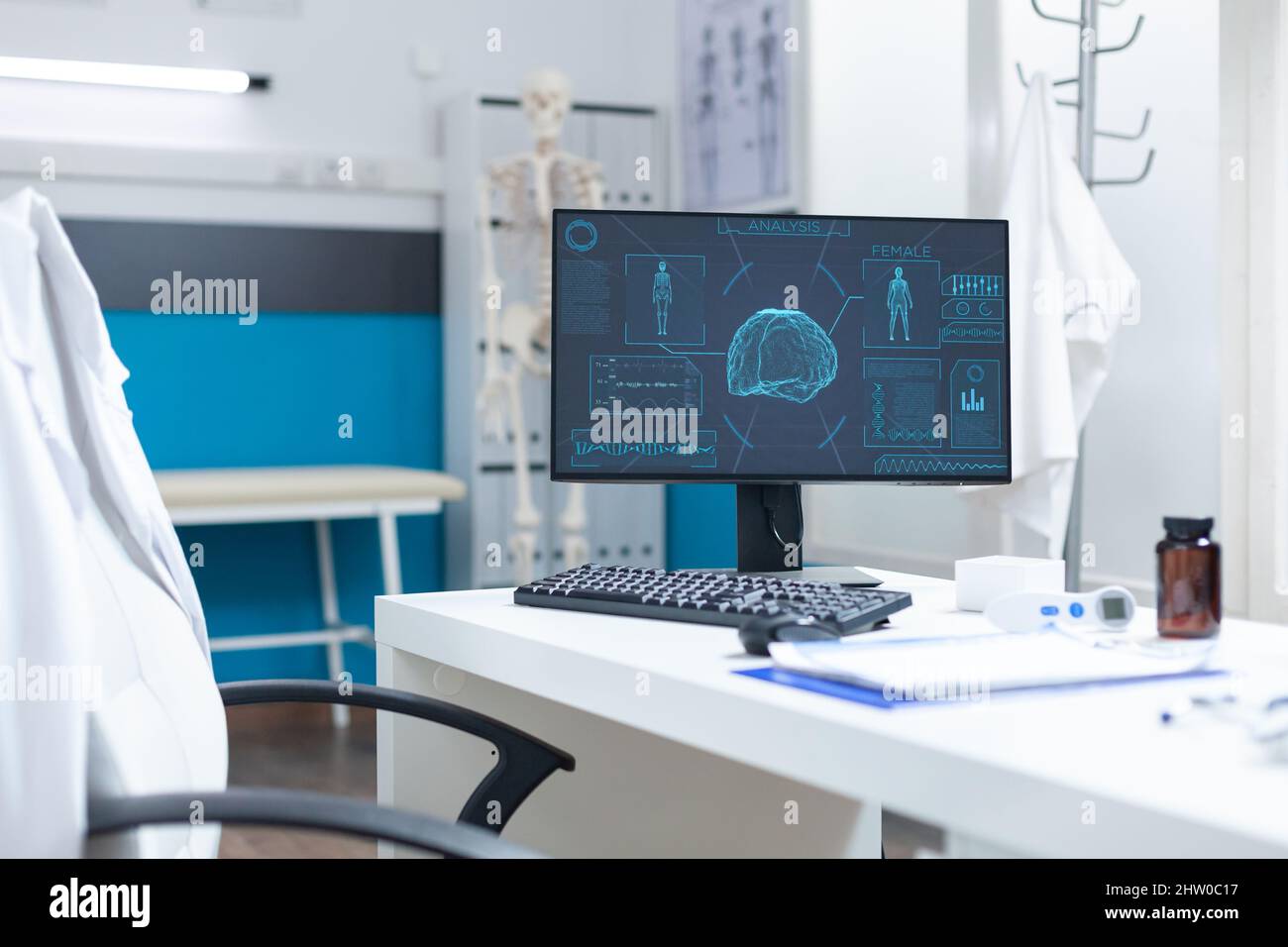 Computer standing on desk in empty bright clinical office having body ...