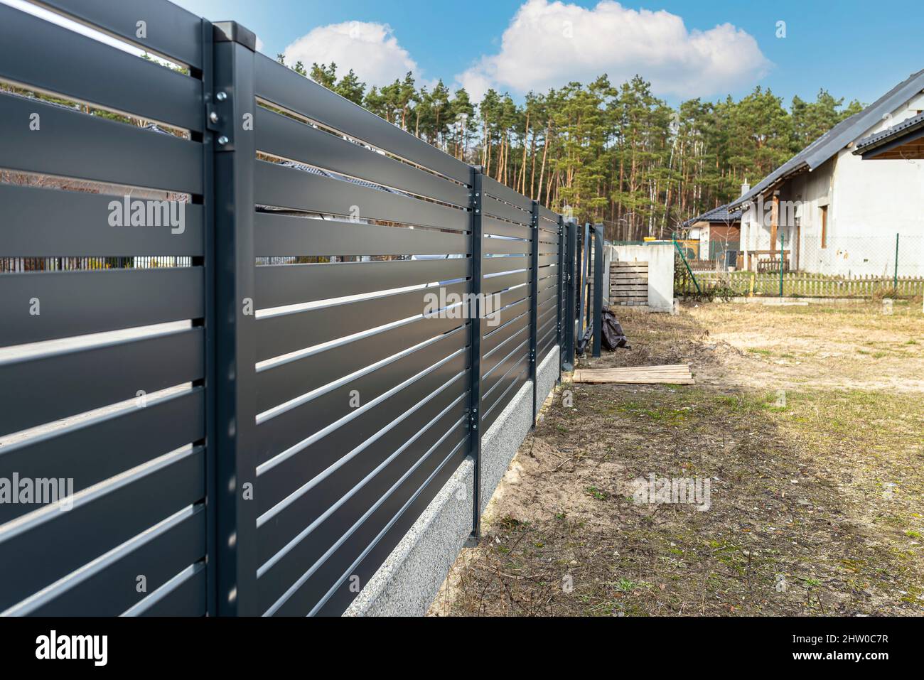 Modern anthracite panel fencing, visible spans and a fence foundation ...