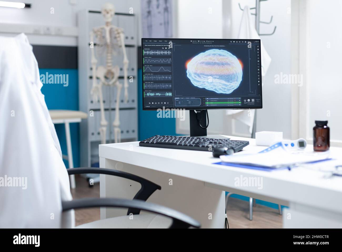 Computer with mri brain on screen standing on table in empty ...