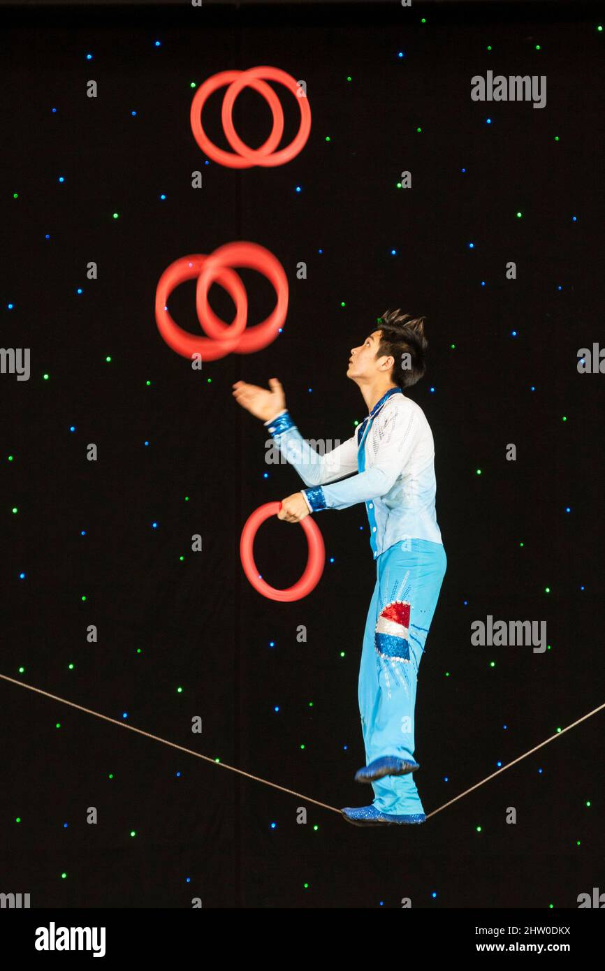 Chinese Juggler Juggling Circular Rings while Balancing on a Tightrope ...