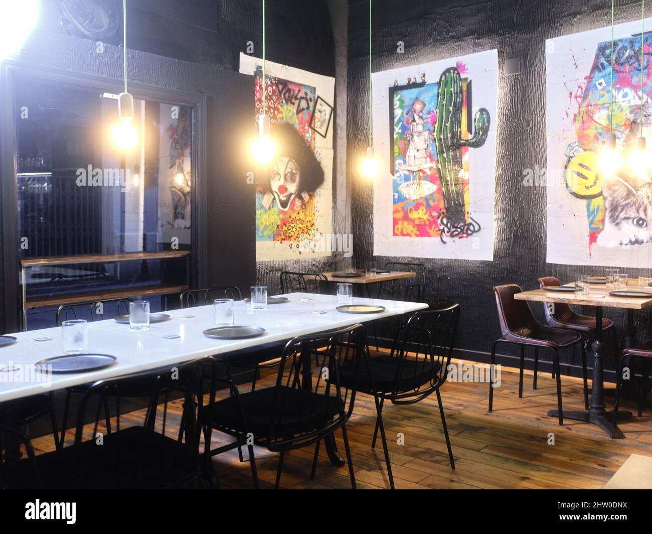 Interior of a modern restaurant decorated with paintings with graffiti ...