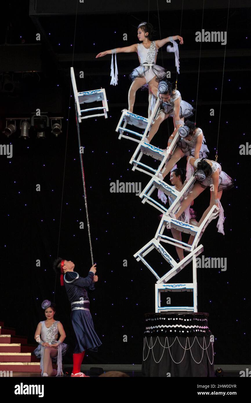 Chinese Women Acrobats Balancing on Chairs Stock Photo - Alamy