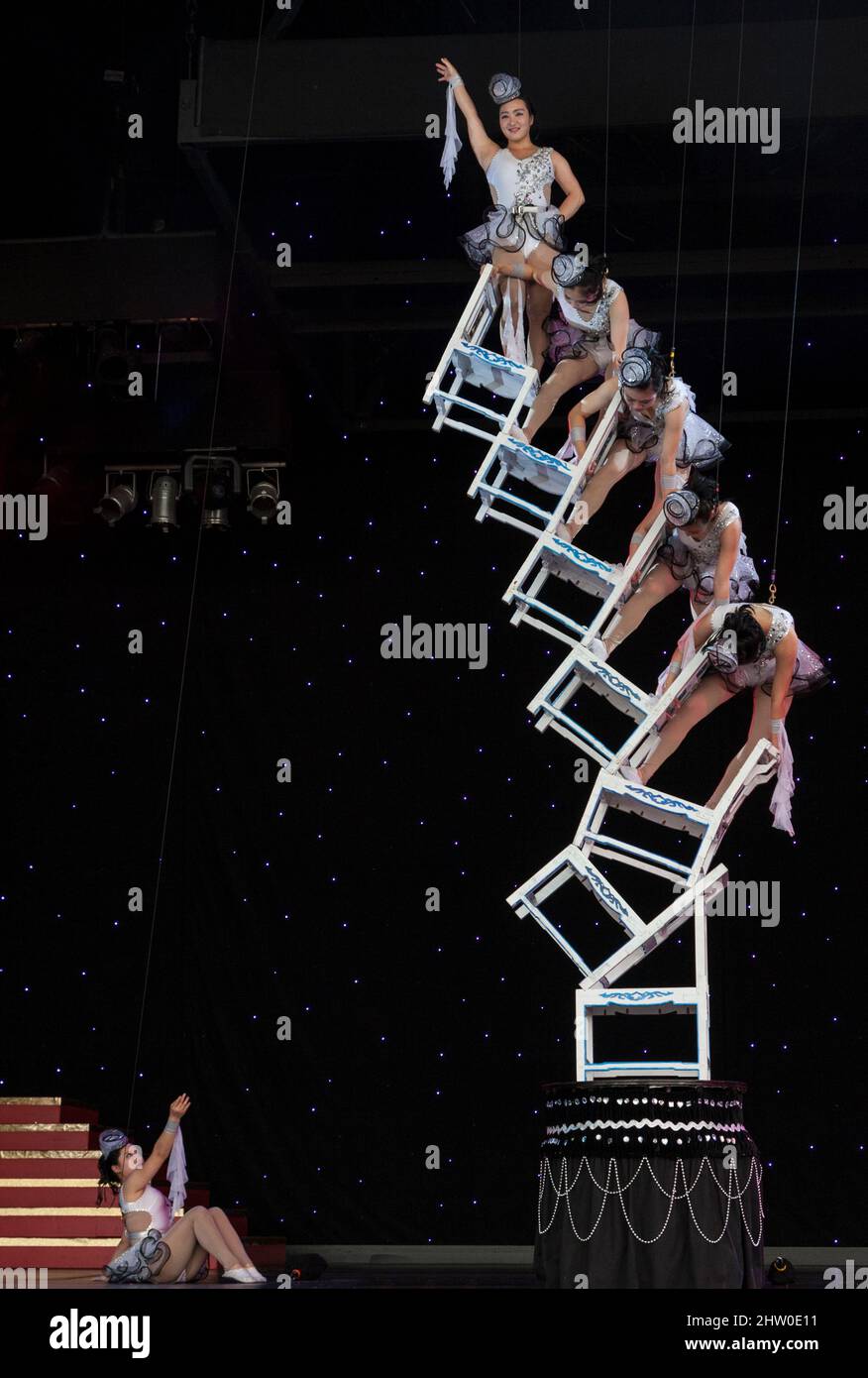 Chinese Women Acrobats Balancing on Chairs Stock Photo - Alamy