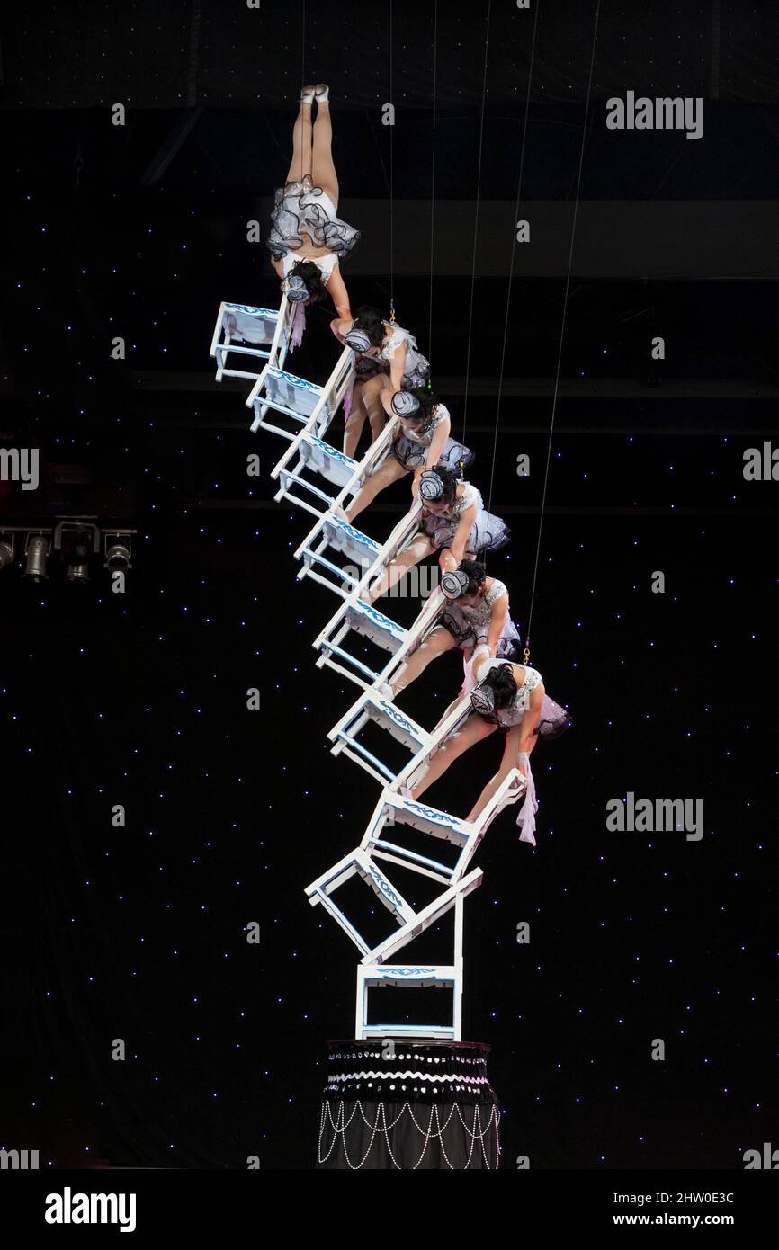 Chinese Women Acrobats Balancing on Chairs Stock Photo - Alamy