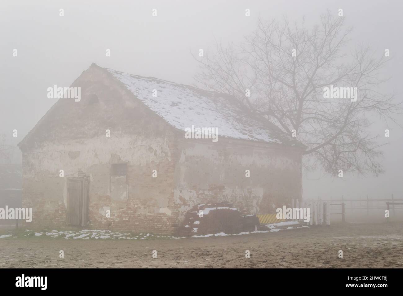 An old farmhouse covered in thick fog Stock Photo - Alamy