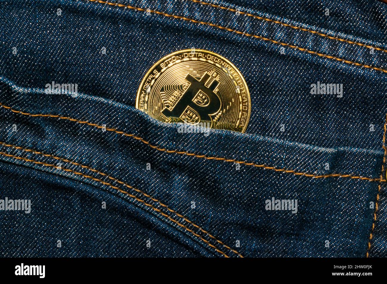 Bitcoin gold coin in jeans pocket investment concept Stock Photo - Alamy