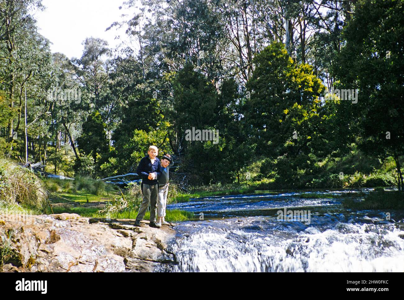 Tow boys standing next to Trentham Falls waterfall, Coliban River ...