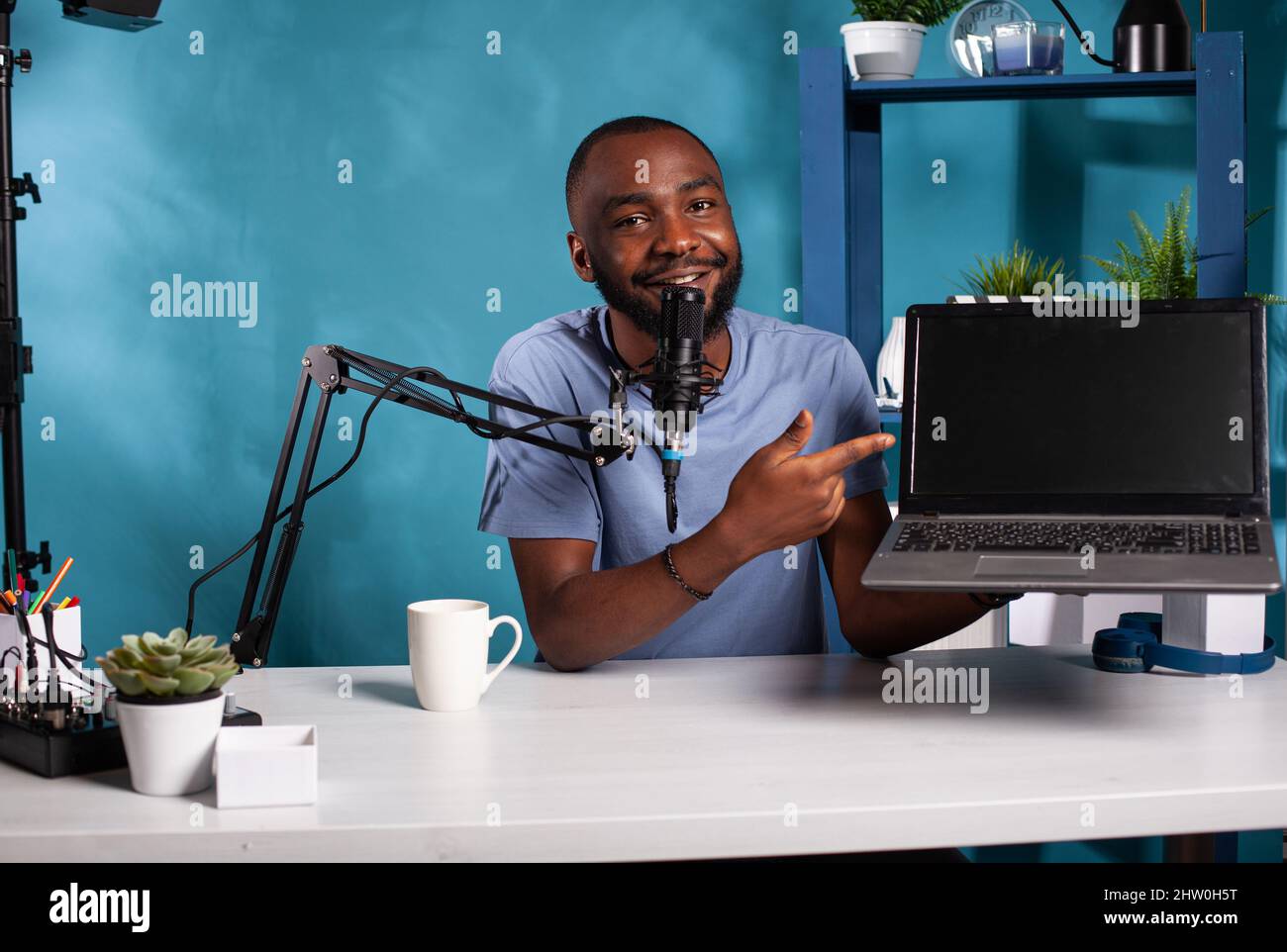 Vlogger recording podcast review for new laptop model pointing out ...