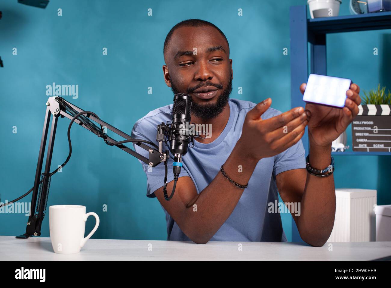 Portrait of african american vlogger looking at new model rgb small ...
