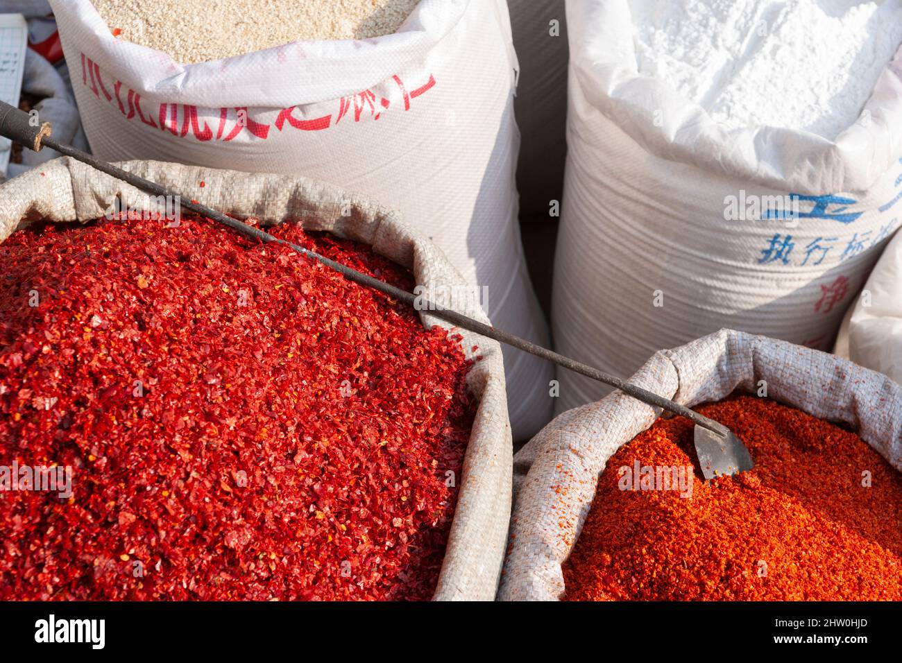 Dry red pepper in bags in an outdoor market, Kashgar, Xinjiang, China ...