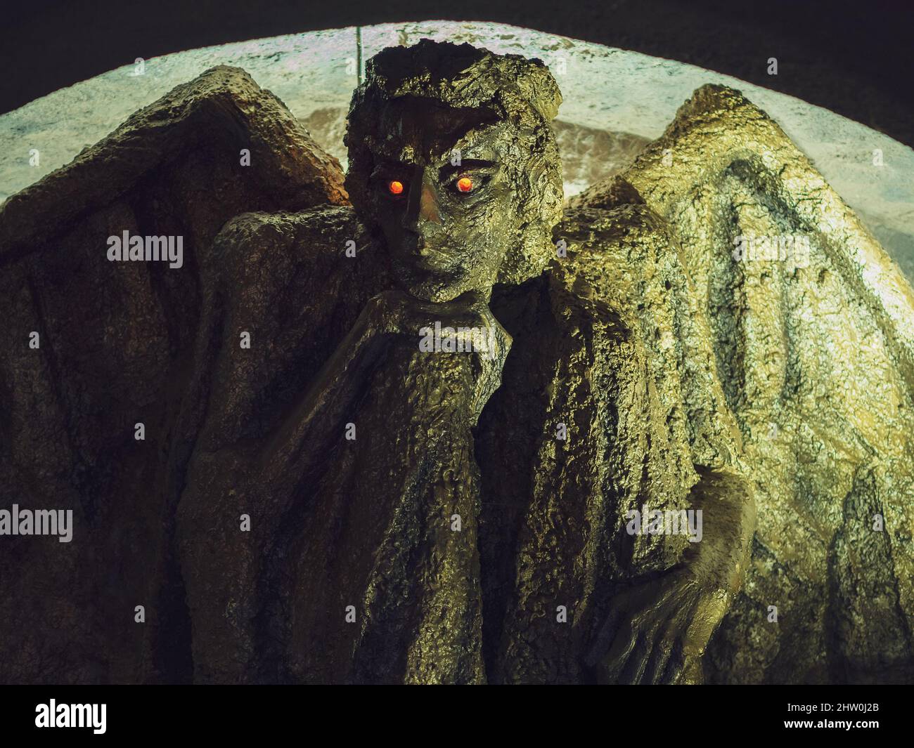 Russia, Kislovodsk 02.11.2021. A gilded statue of a demon with glowing ...