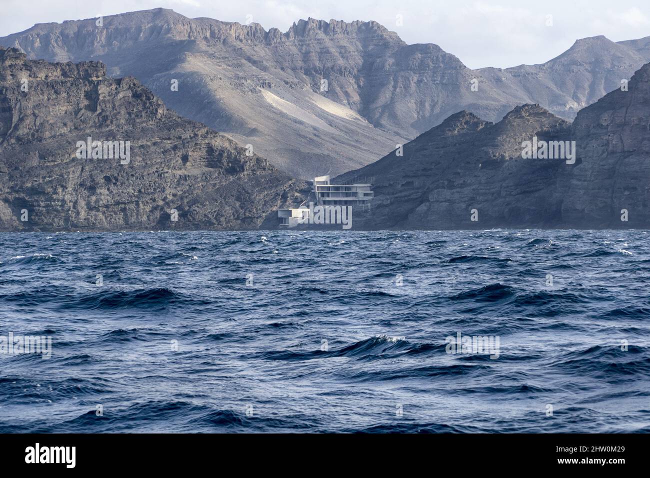 Beautiful view of the blue sea with a rocky hills on the shore ...