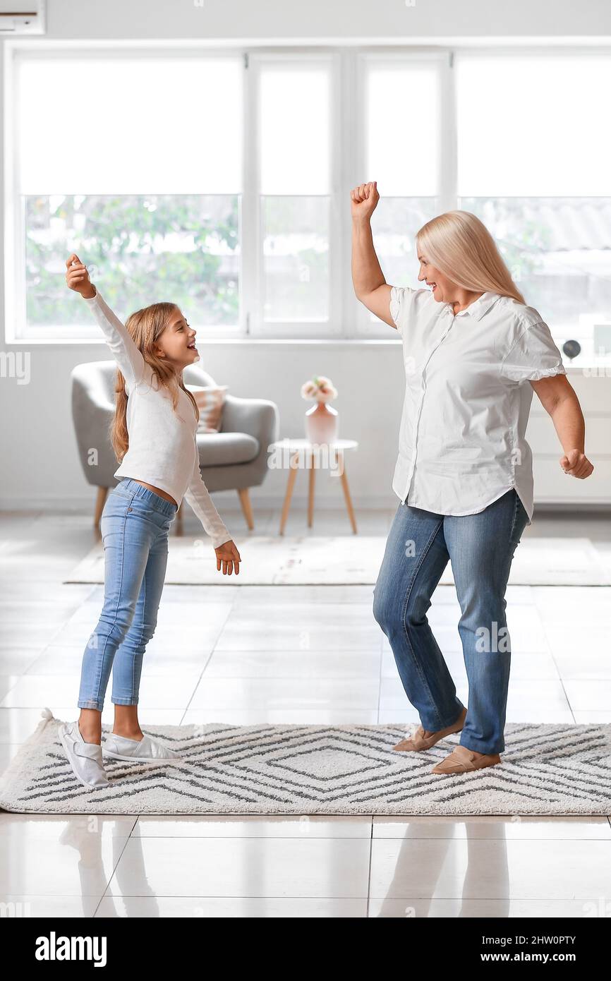 Little girl dancing with her grandma at home Stock Photo - Alamy