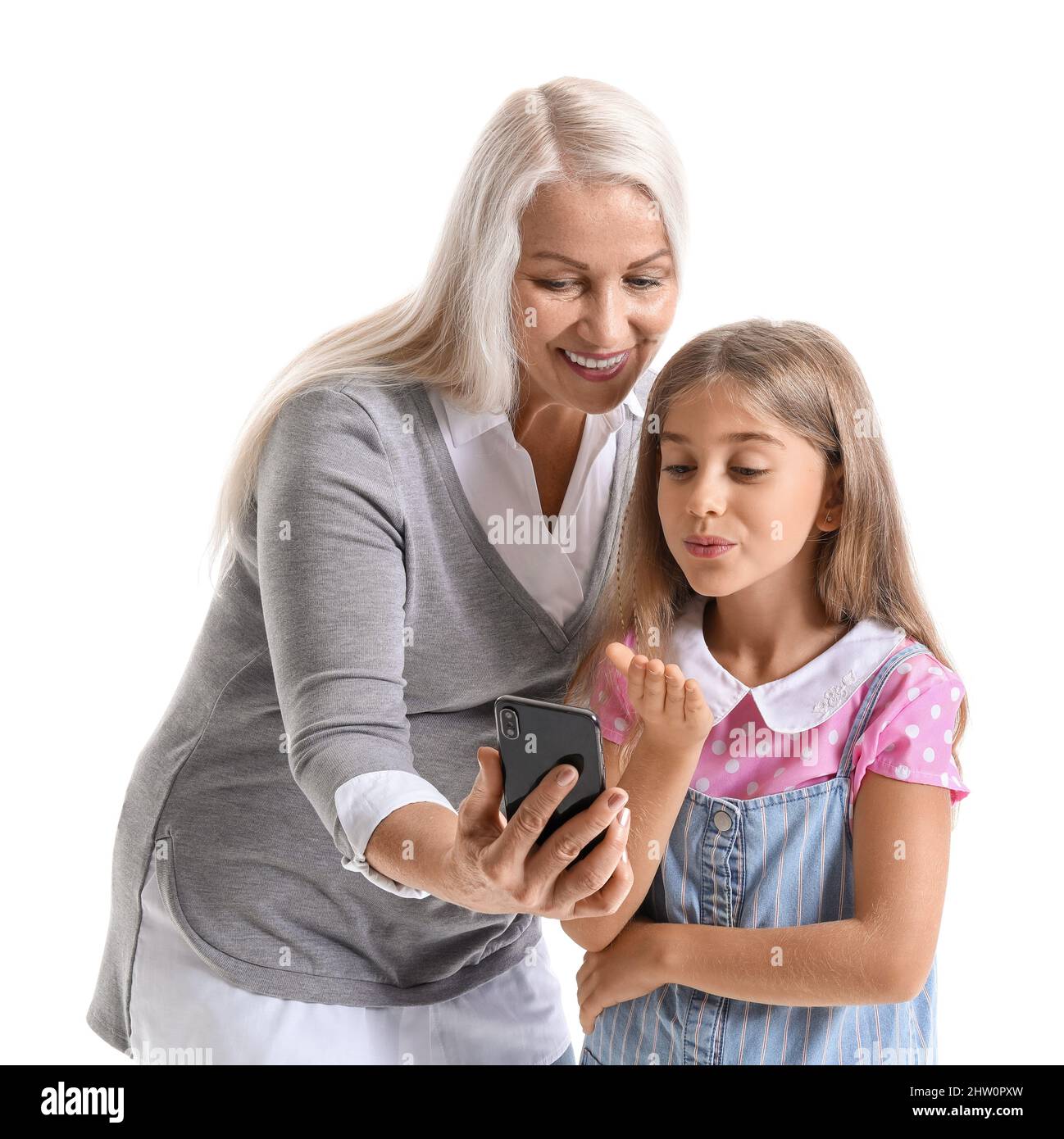 Little girl with her grandma taking selfie on white background Stock ...