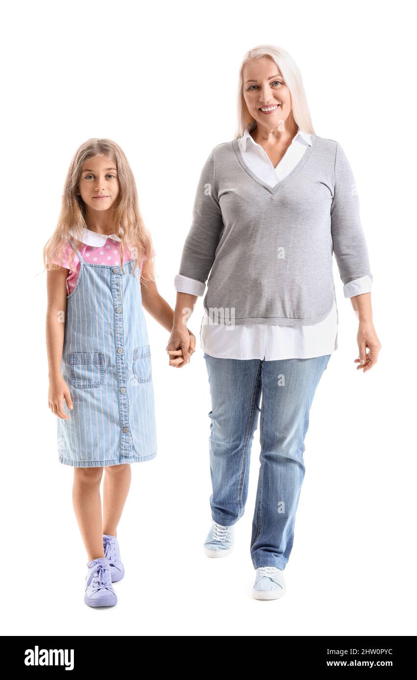 Little girl with her grandma walking on white background Stock Photo ...