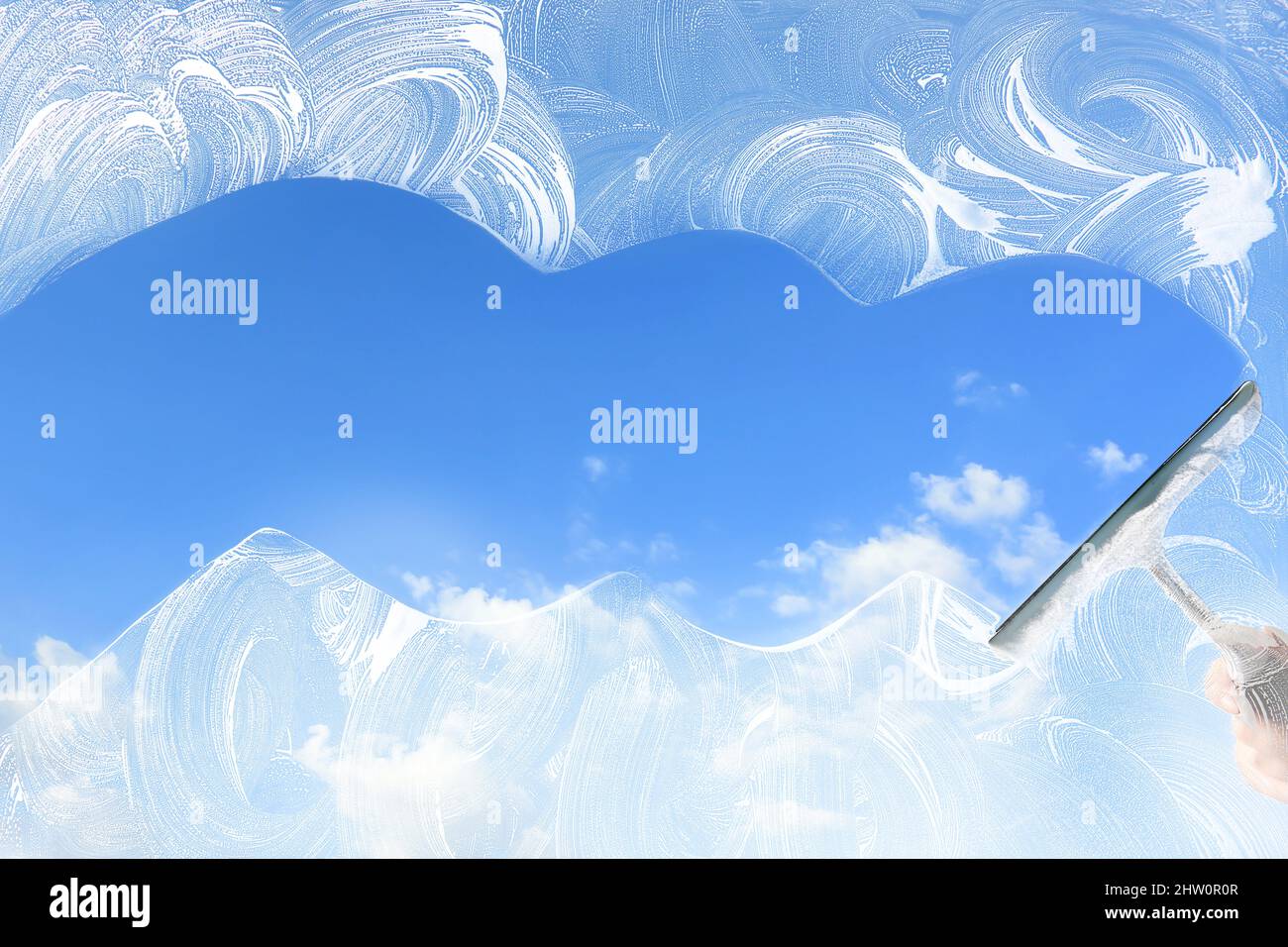 Washing of window with detergent and squeegee against blue sky Stock ...