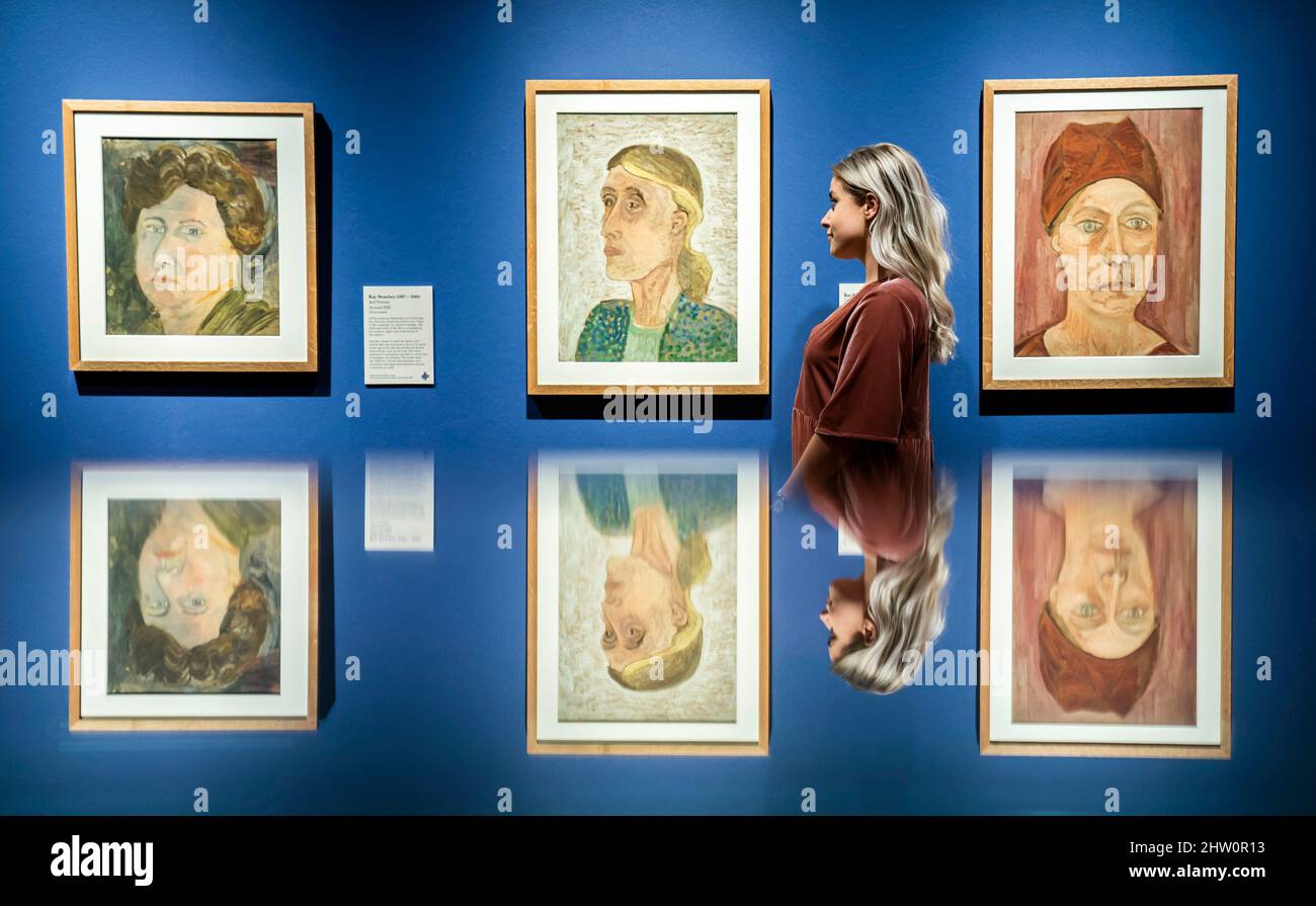 Millie Carroll is reflected in a glass display cabinet, as she views ...