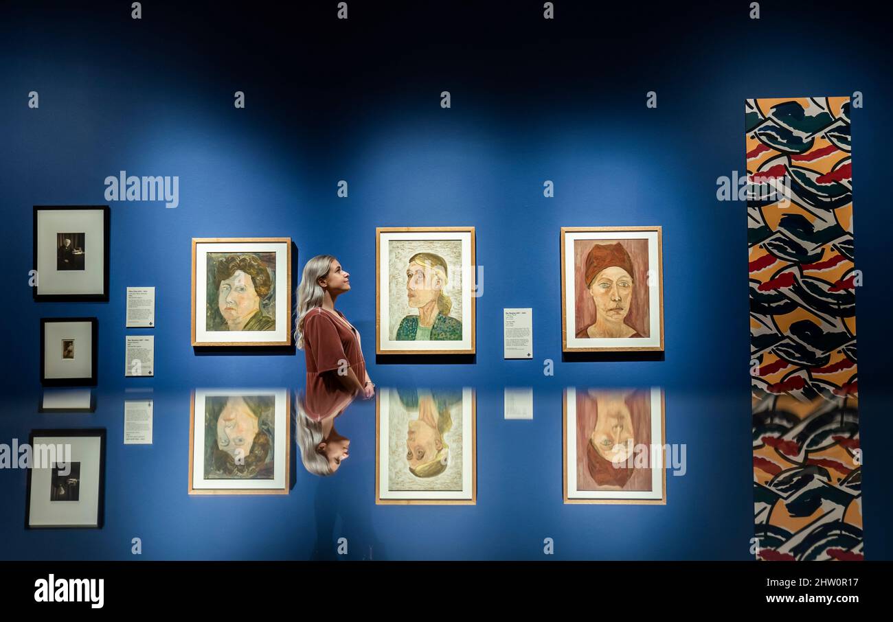 Millie Carroll is reflected in a glass display cabinet, as she views ...