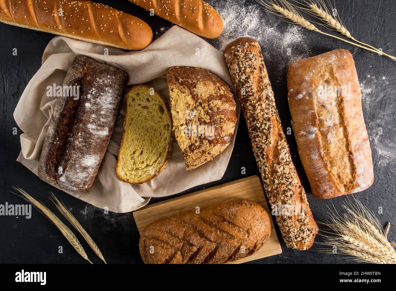 bread background. a wide variety of bread loaves made of different ...