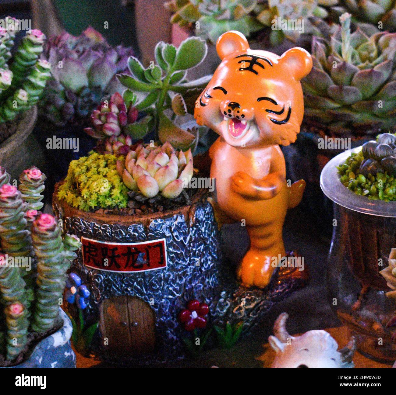 Decoration with a tiger for flowers in a shop Stock Photo - Alamy
