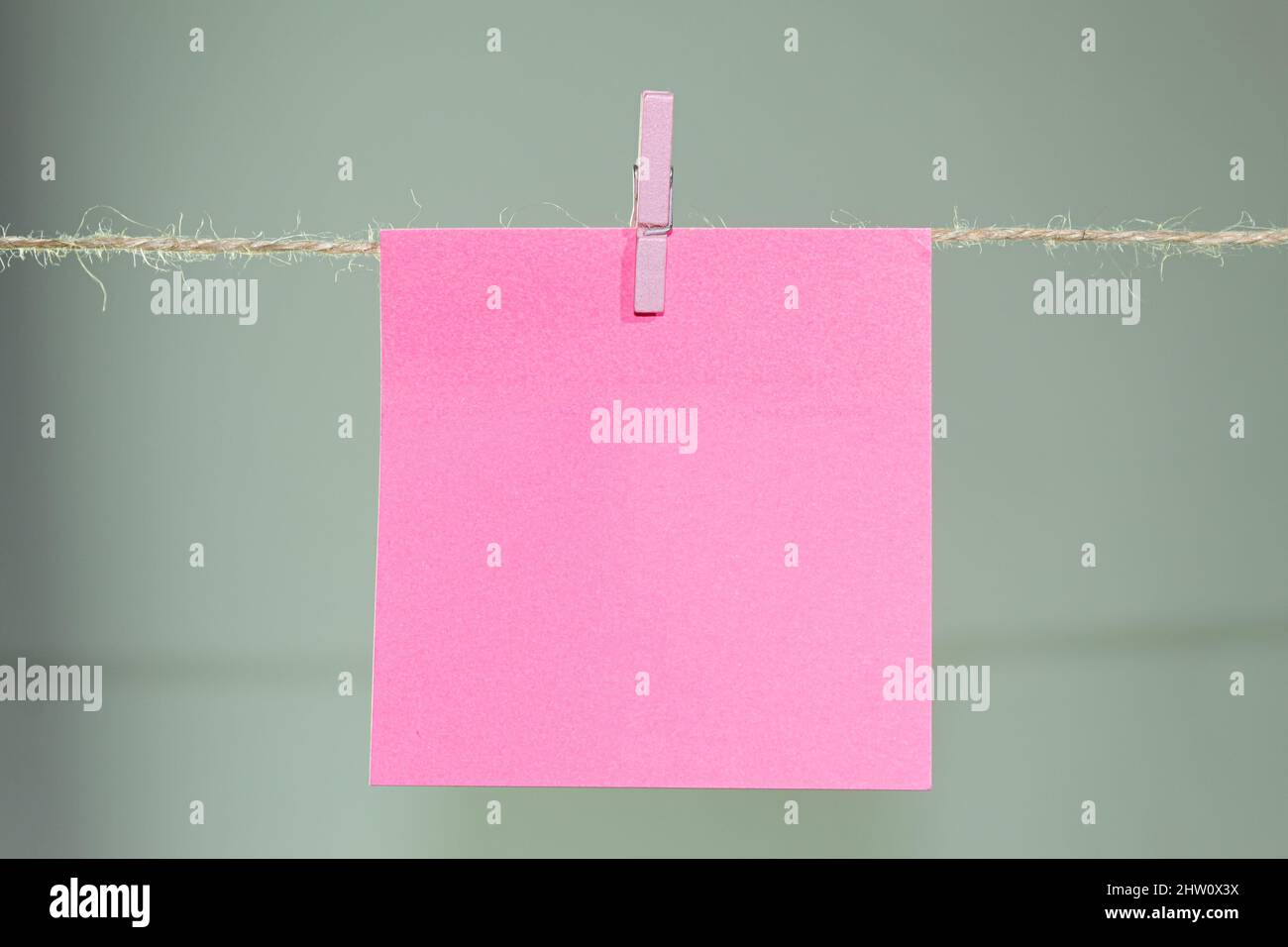 The paper for the text is suspended from a rope. Photo frames hanging ...