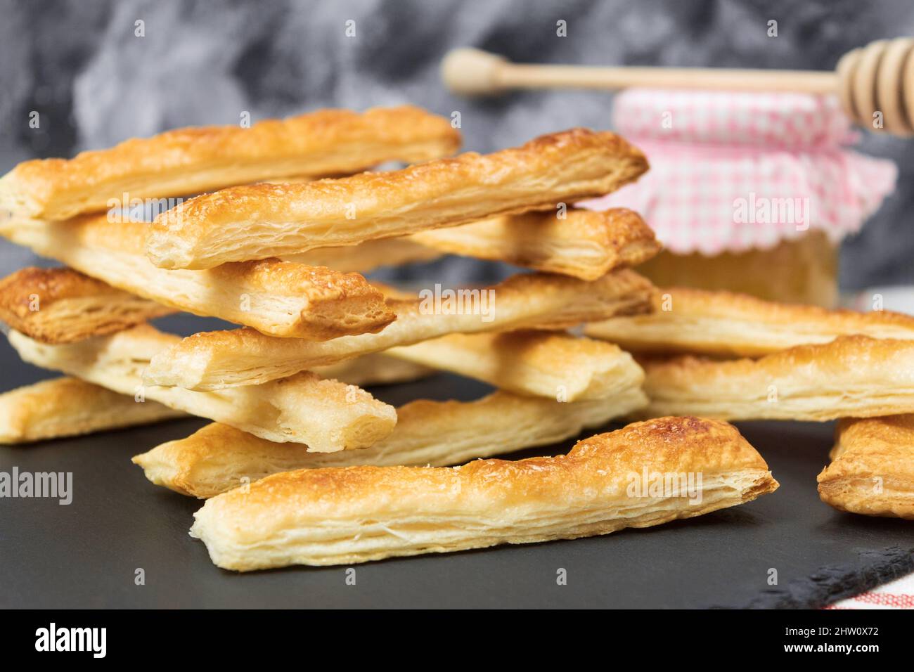Delicious and sweet puff pastry sticks with cinnamon. Background with ...