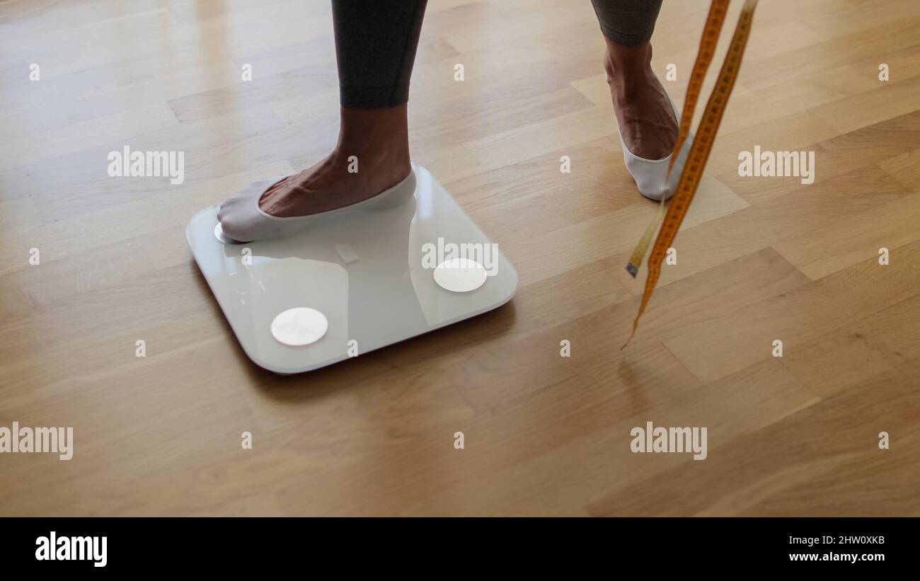 Woman step on Weighing Scale for Measuring Body Weight At Home Stock ...