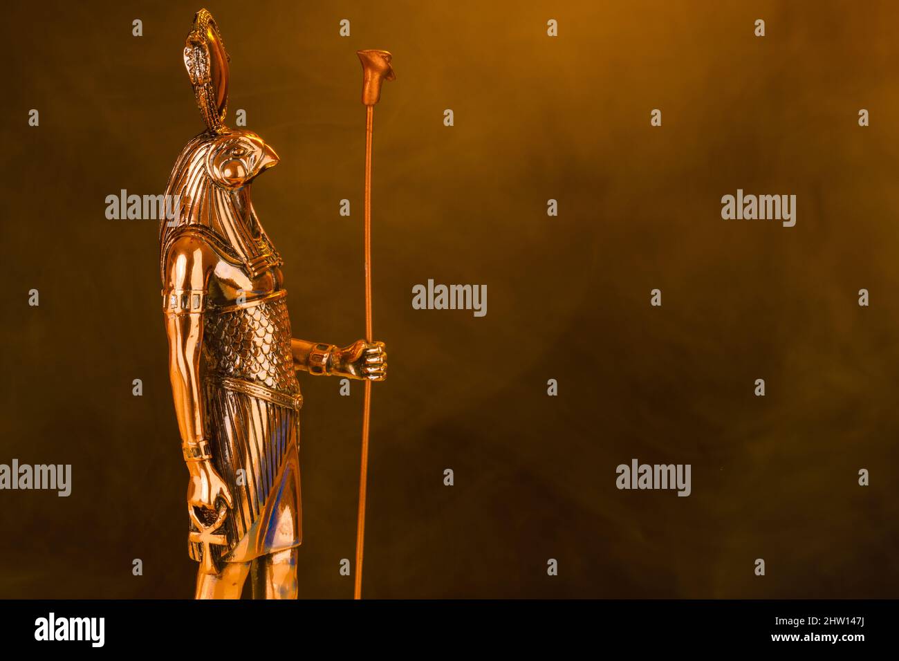 metal golden statue of the Egyptian sun god Ra on a black background ...