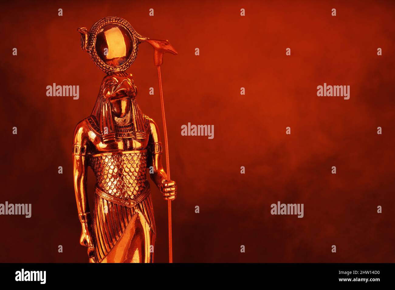 metal golden statue of the Egyptian sun god Ra on a black background ...