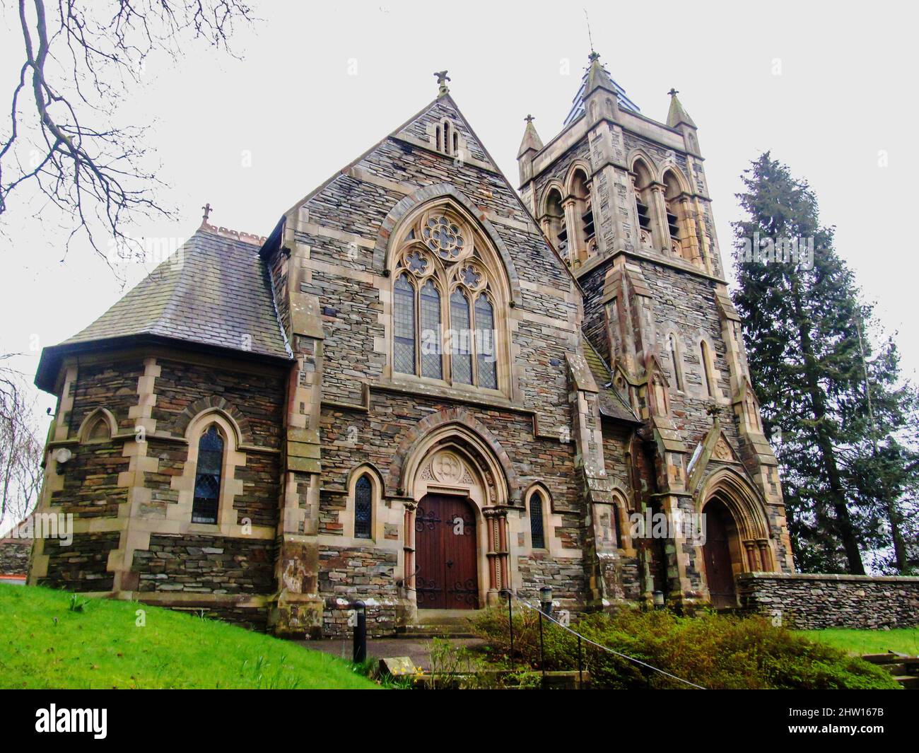 A small stone church on a wet day in the town of Bowness on Windermere ...