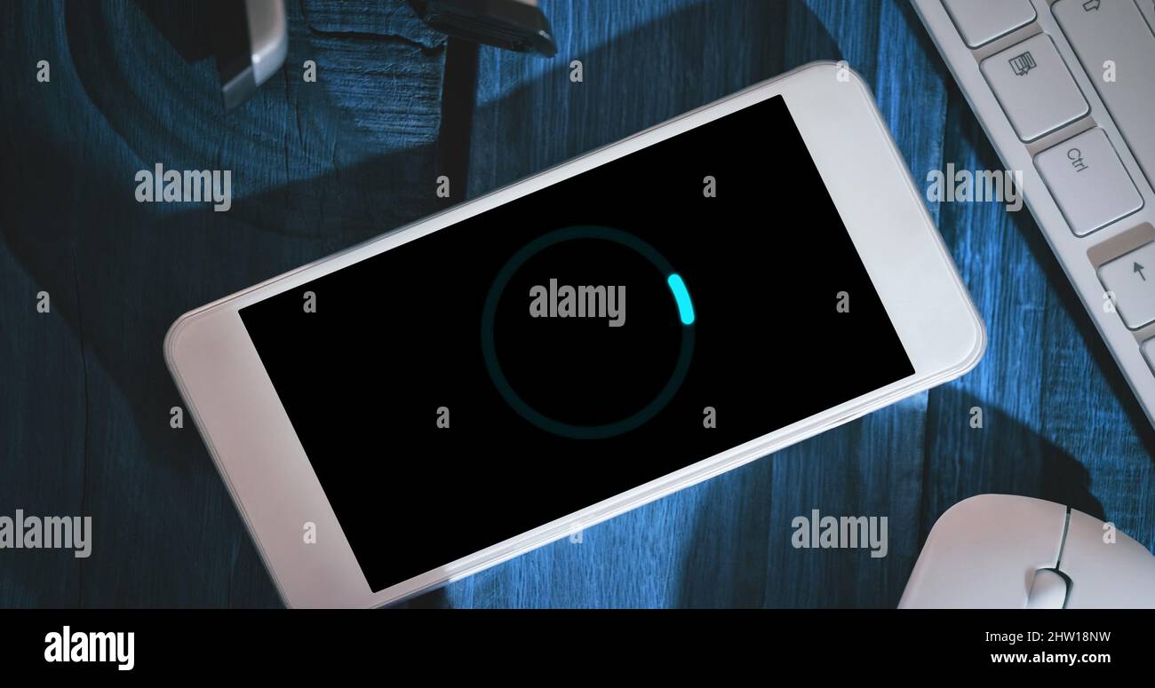 Image of loading circle on smartphone in office Stock Photo - Alamy