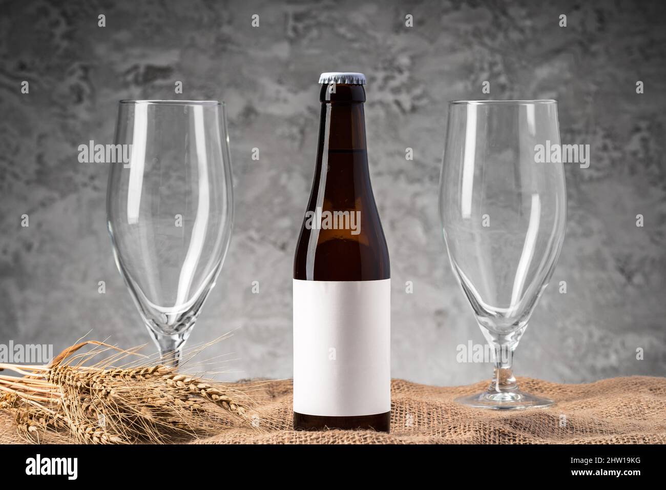 Beer bottle and beer glass against gray background Stock Photo - Alamy