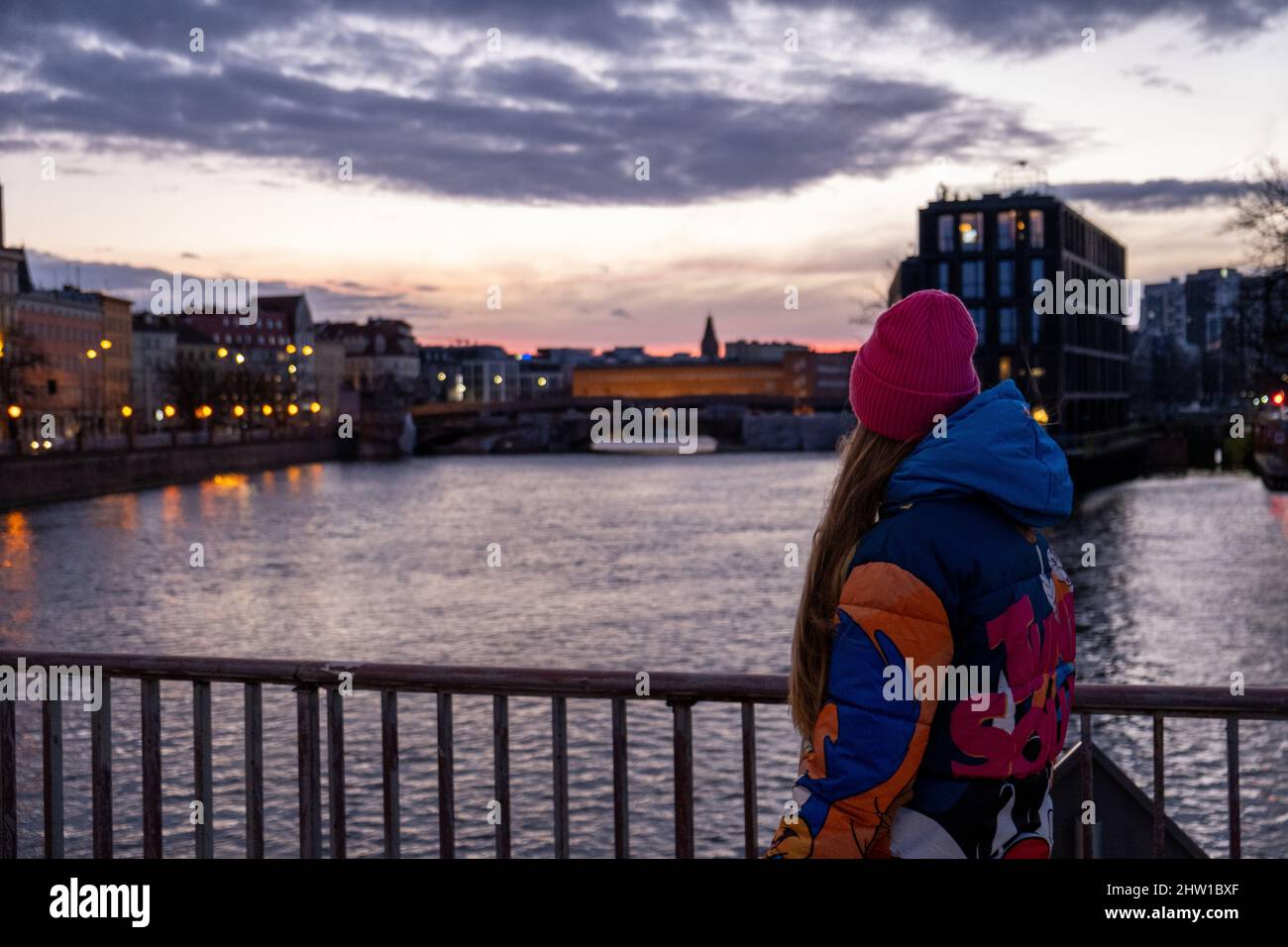 Shallow focus shot of a female on a bridge wearing thick clothes and ...