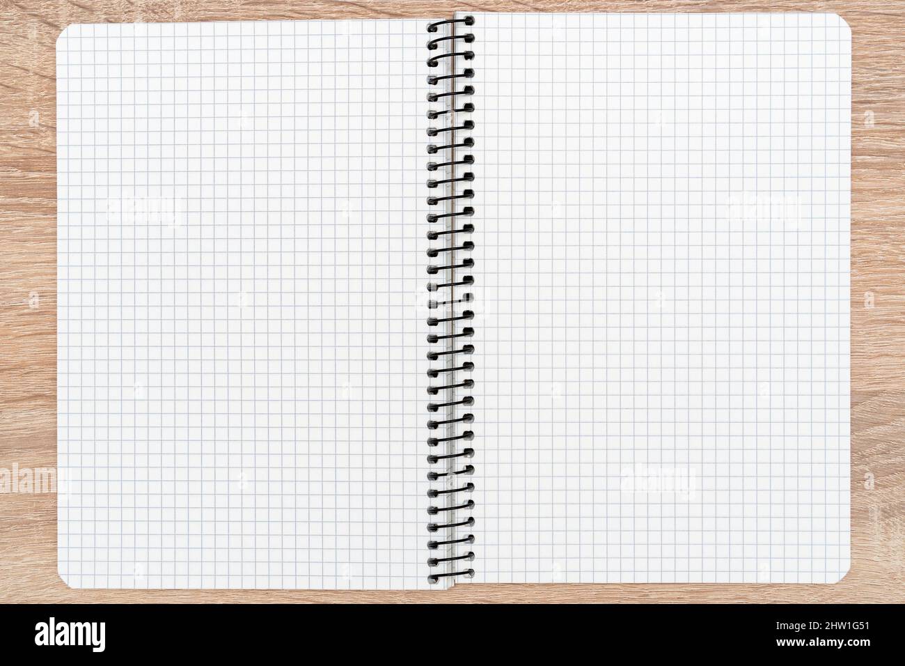 Open blank white square ruled spiral bound notebook with copy-space ...