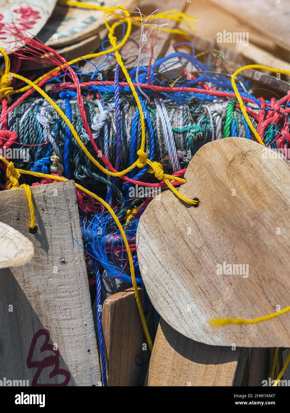 Many suspended chaotically intertwined colorful ropes tied into messy ...