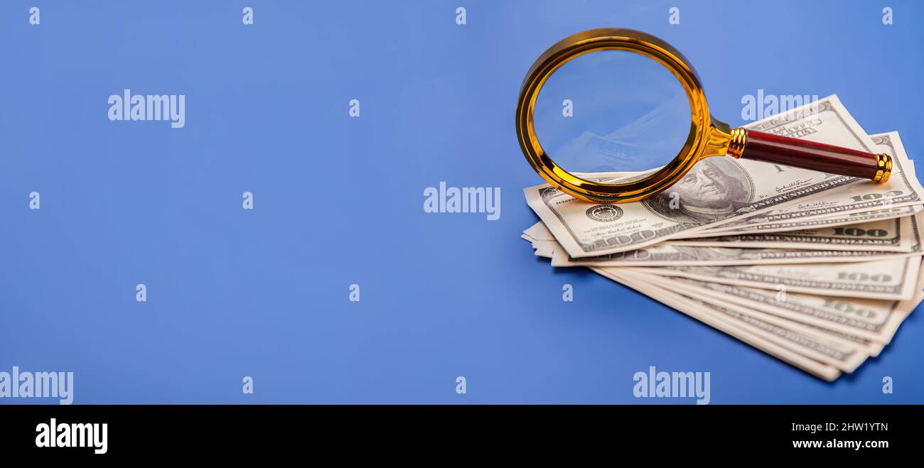 Money with a magnifying glass. Finding profits and losses. A bus Stock ...