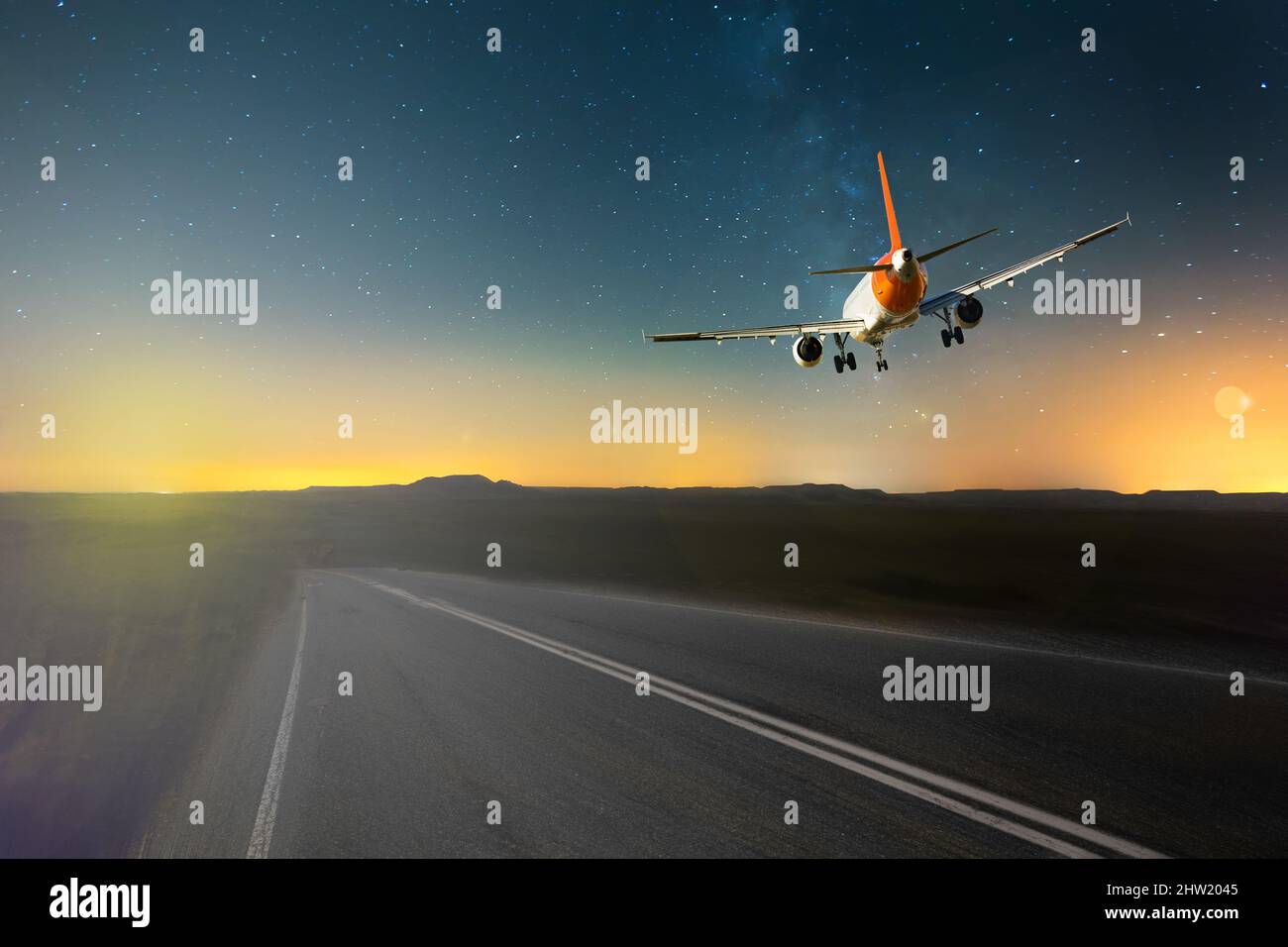 Airplane flying over roadway Stock Photo - Alamy