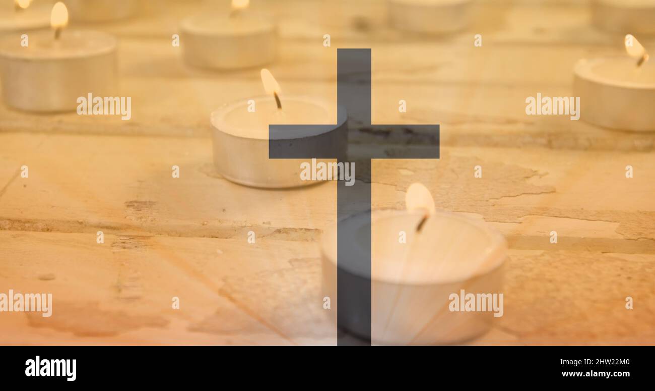 Image of black crucifix shape over burning tealights Stock Photo - Alamy