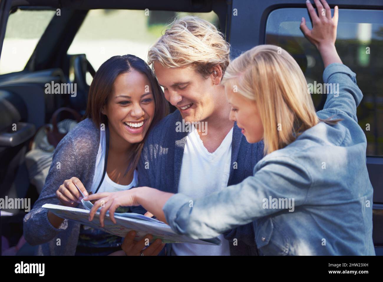 Lets get lost for fun. Portrait of a group of friends leaning against ...
