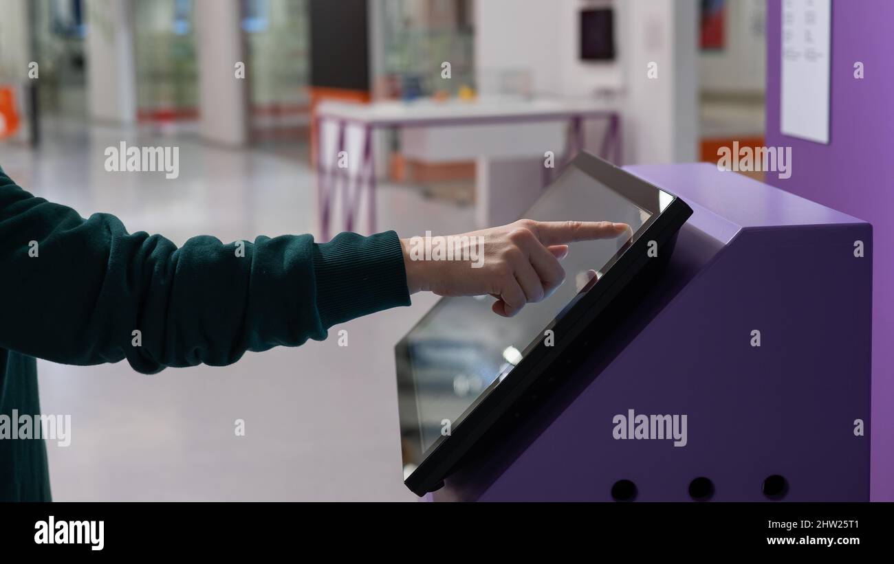 Close-up of a woman using a touch screen information booth Stock Photo ...
